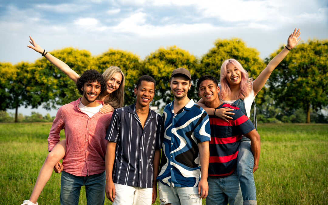 Group of multiethnic teenagers spending time outdoor on a picnic ...